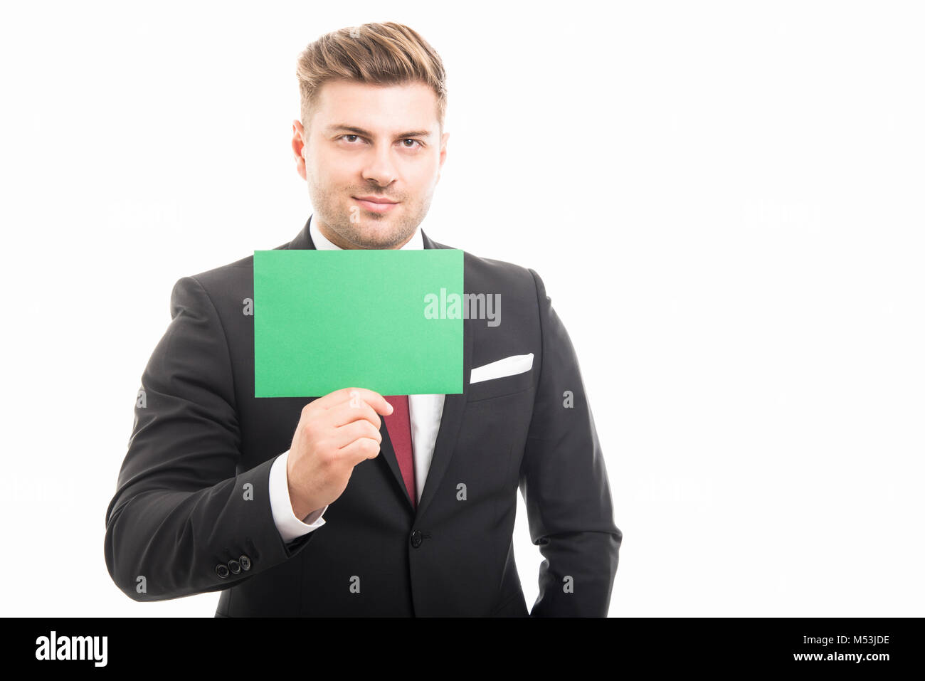 Handsome manager showing blank green cardboard isolated on white ...