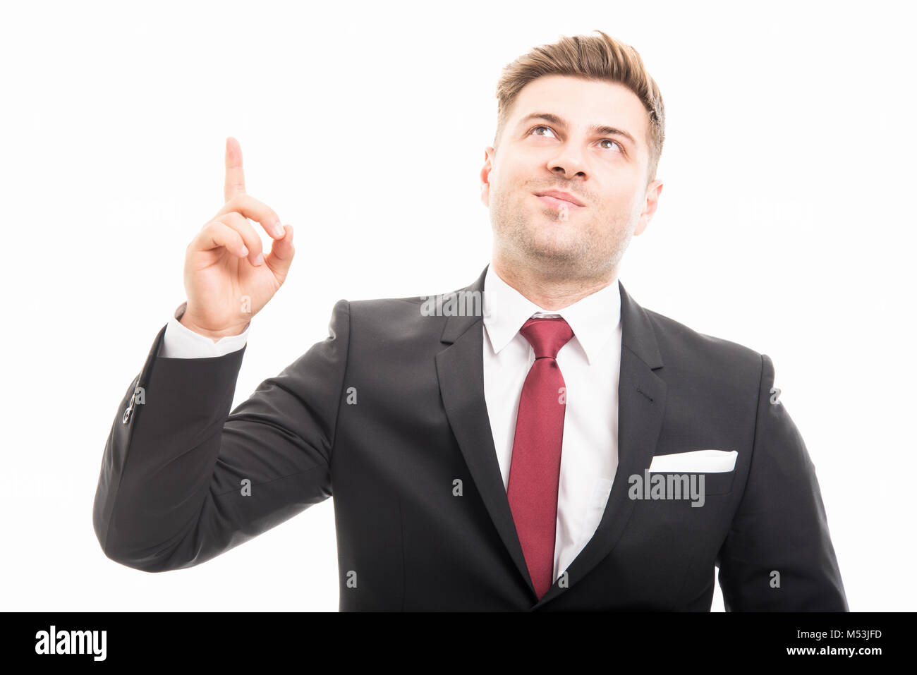 Handsome manager wearing suit pointing and looking up isolated on white ...