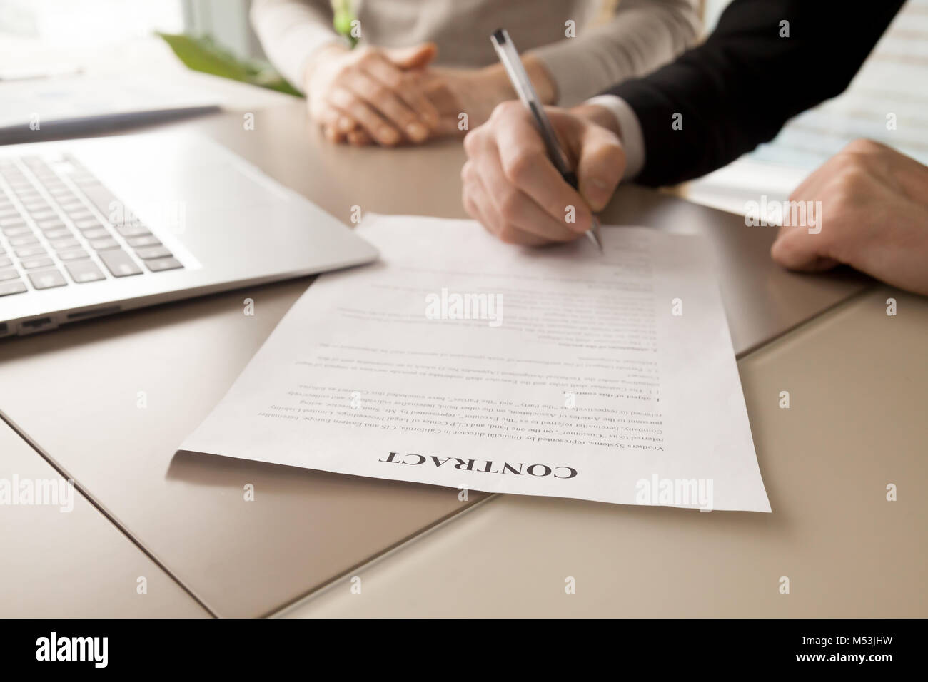 Female and male business partners signing contract Stock Photo - Alamy