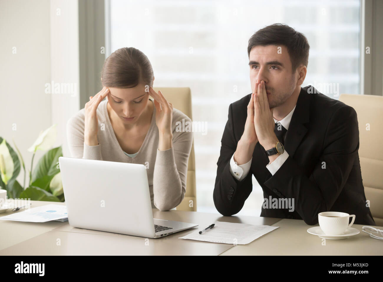 Worried employees thinking about hard decision Stock Photo - Alamy