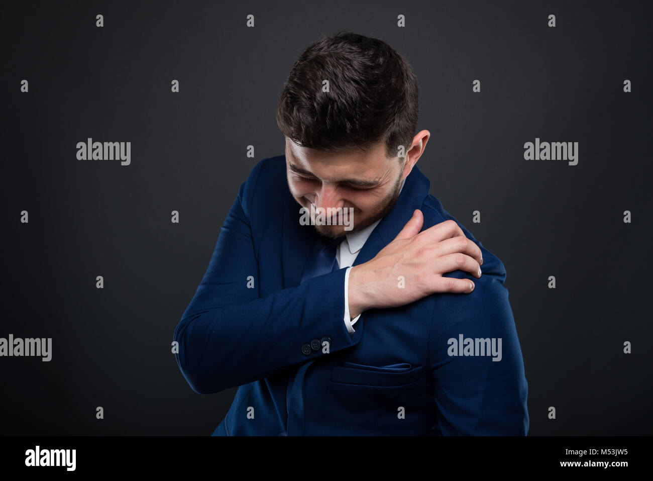 businessman having shoulder pain and painful expression Stock Photo - Alamy