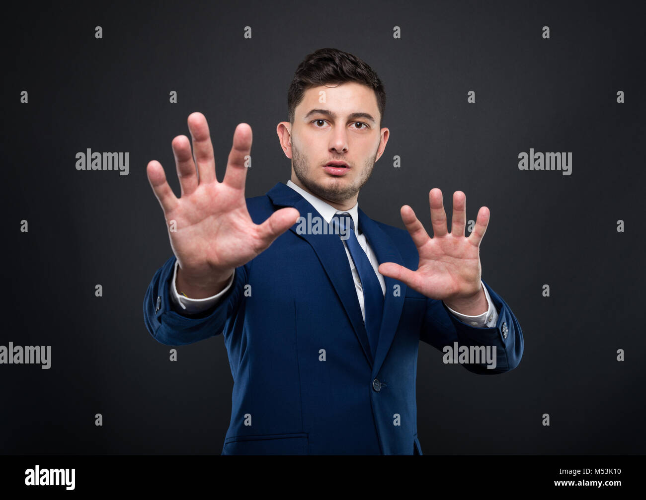 Scared ceo keeping away from danger and doing a rejection gesture with ...