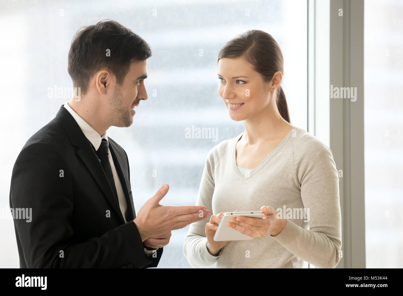Businessman planning work schedule with secretary Stock Photo - Alamy