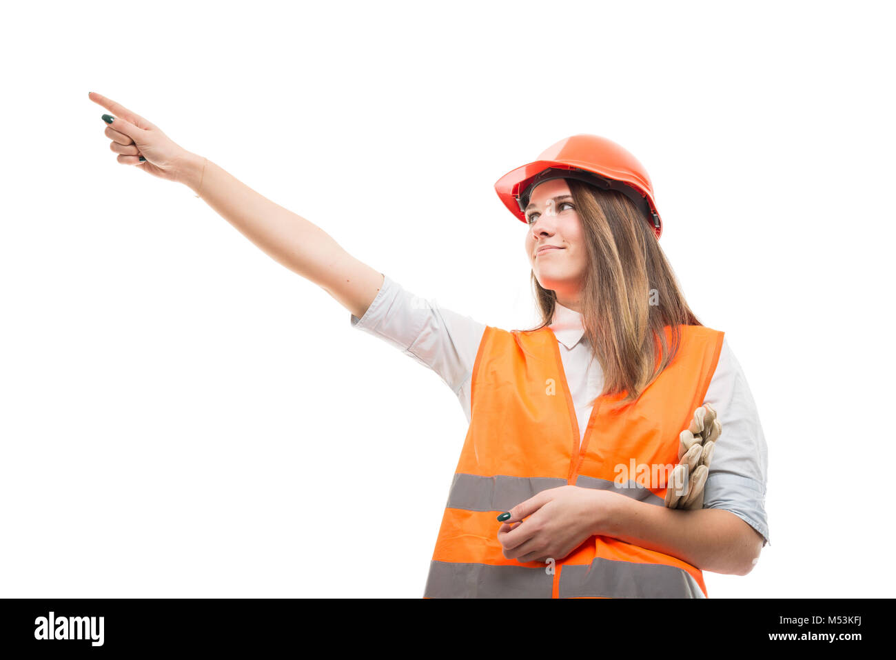 Young female builder pointing up for something on white studio ...