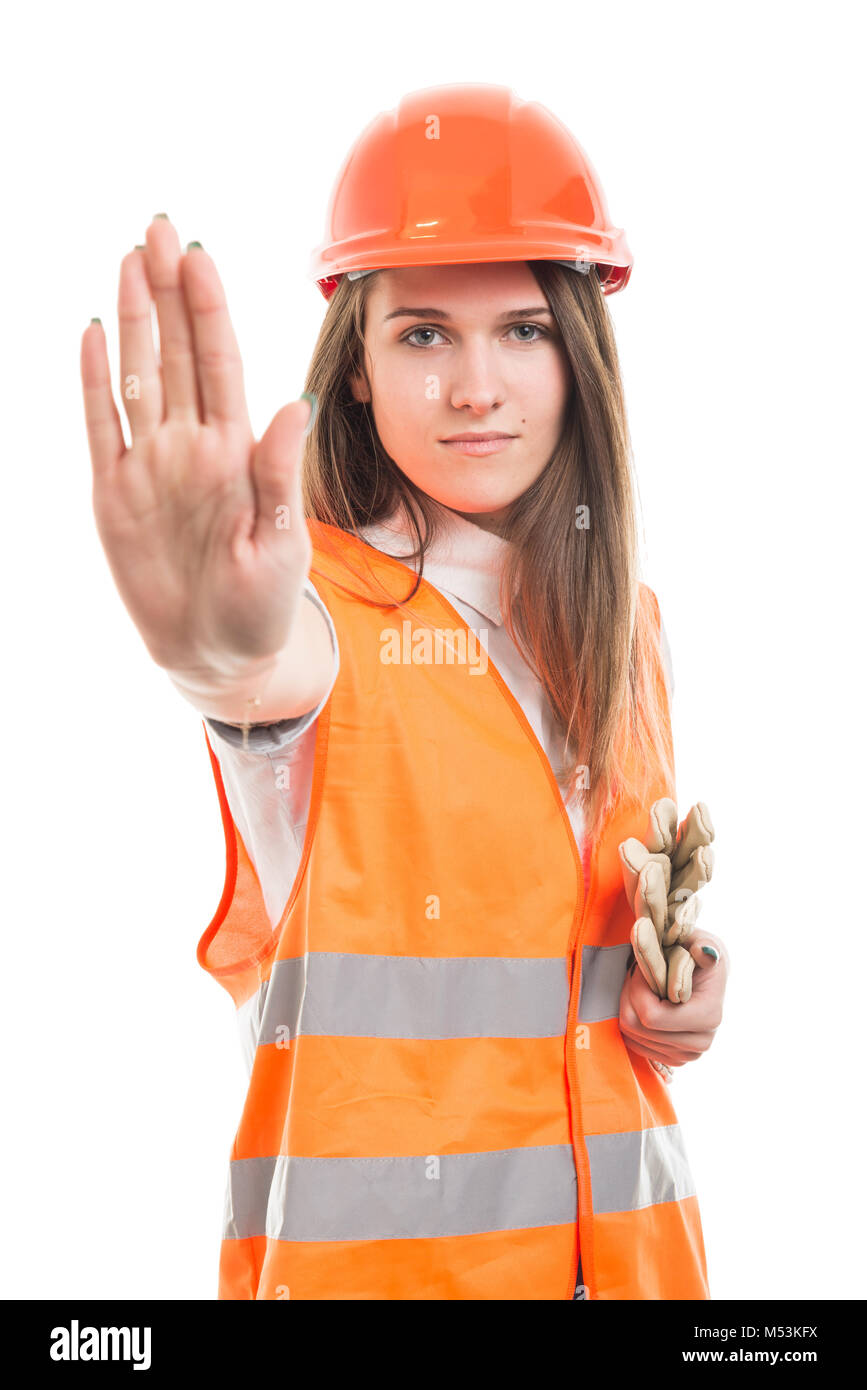 Worker woman making stop sign with her palm wearing protection ...