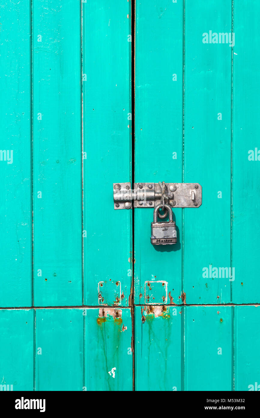A blue green locked door on the sea front at Brixham Stock Photo - Alamy