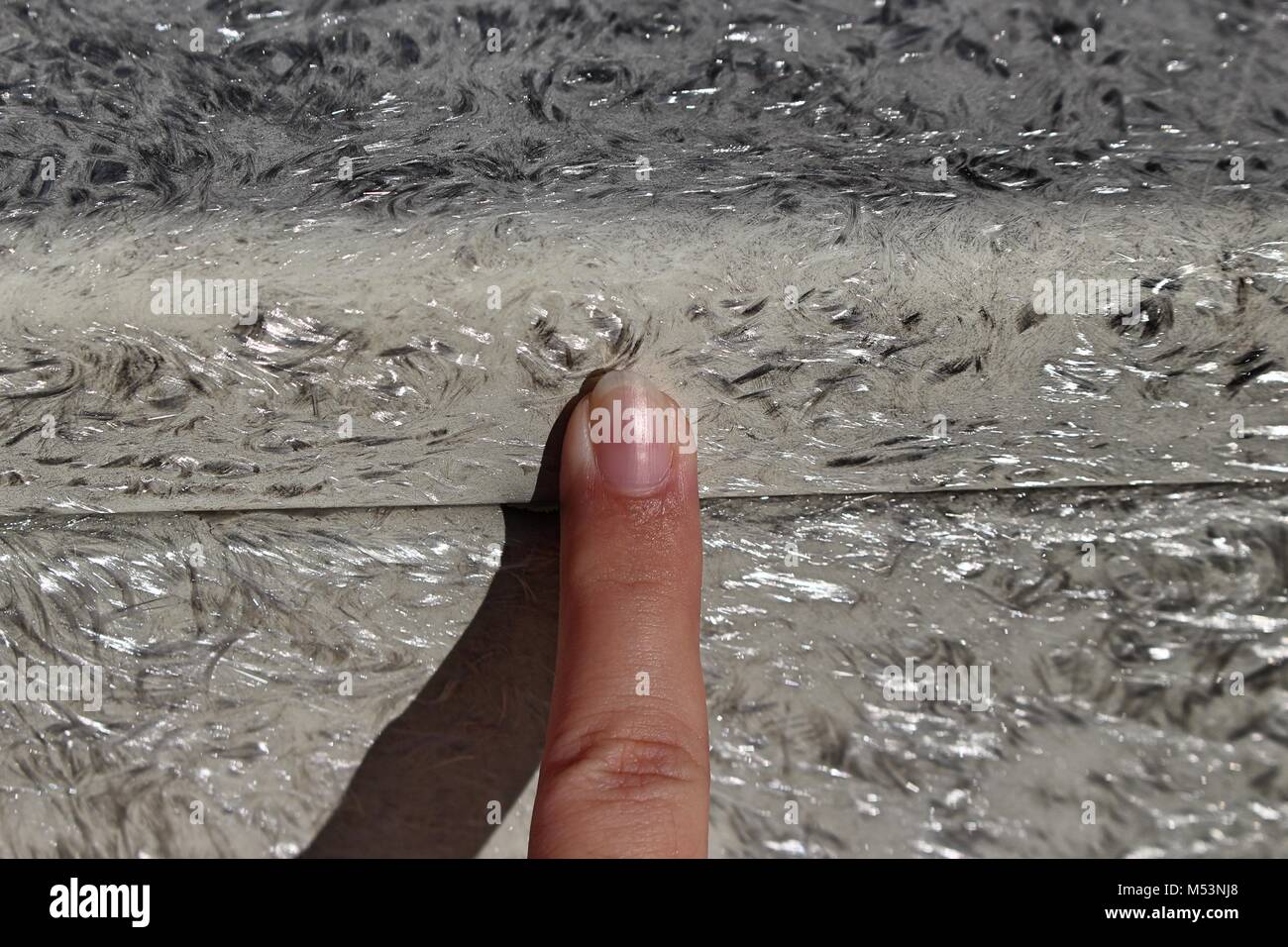 touching a finger on fiberglass Stock Photo - Alamy