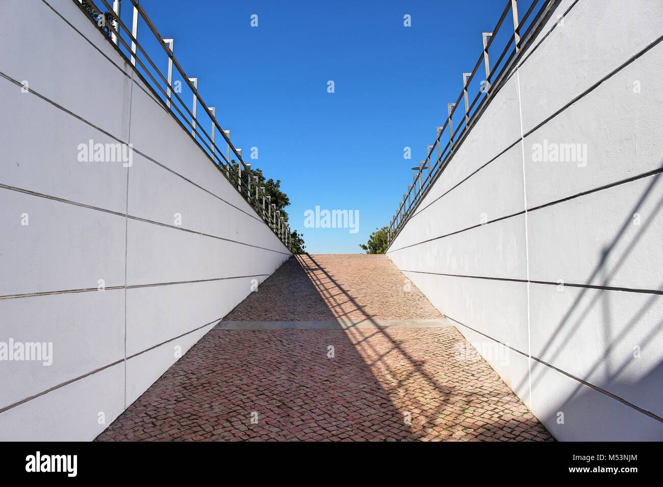 vanishing point on a pathway at the entrance of a park Stock Photo - Alamy
