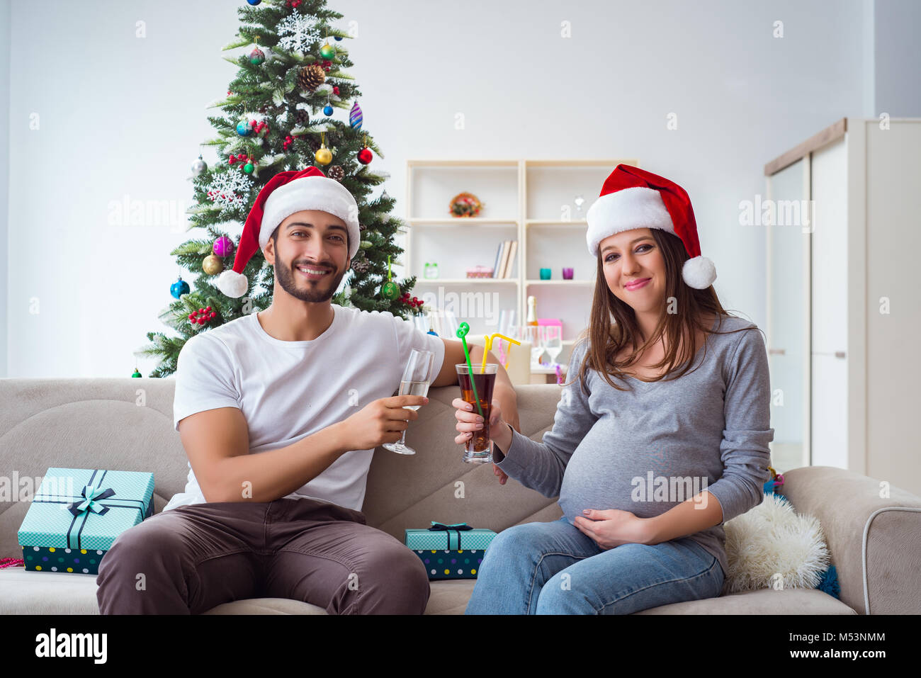 Young family expecting child baby celebrating christmas Stock Photo - Alamy