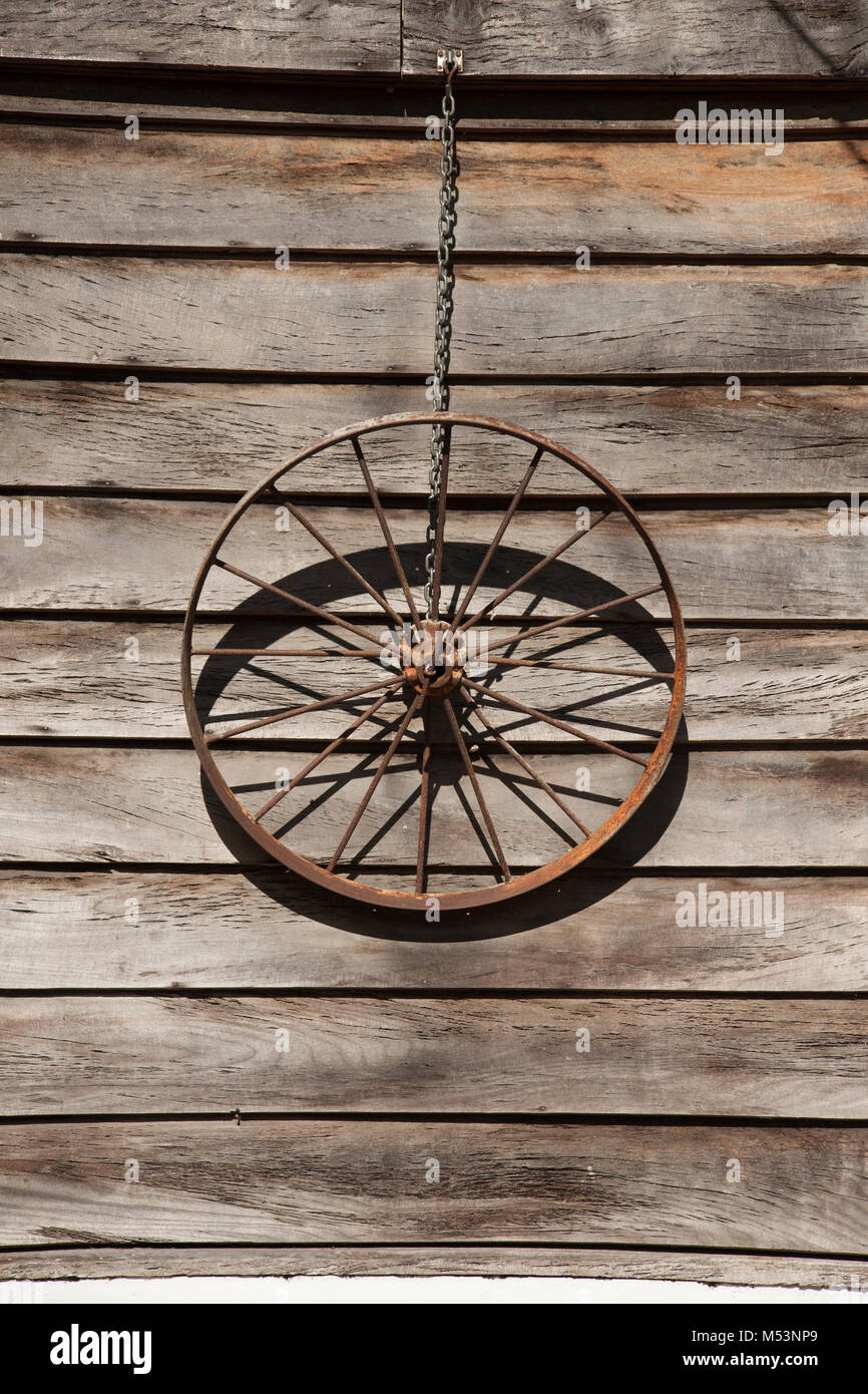 The frame of an old wagon carriage wheel hung by a chain Stock Photo ...