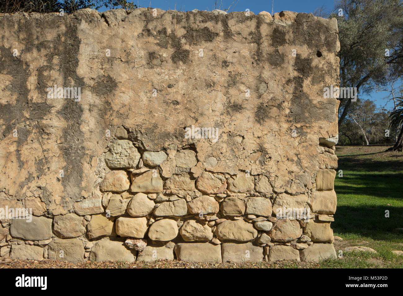 Detail shot at eye level of a worn sandstone wall with eroding features ...