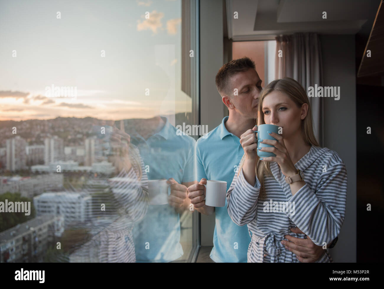 romantic happy young couple enjoying evening coffee and beautiful ...