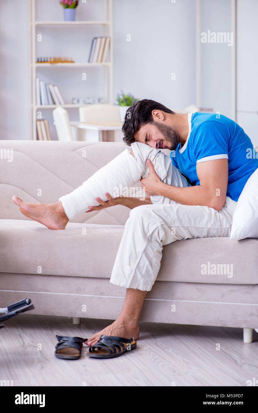 Injured young man recovering at home Stock Photo - Alamy