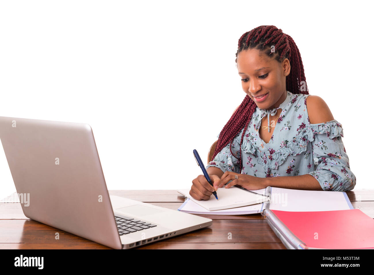 Young african student working with her laptop, isolated over a white ...