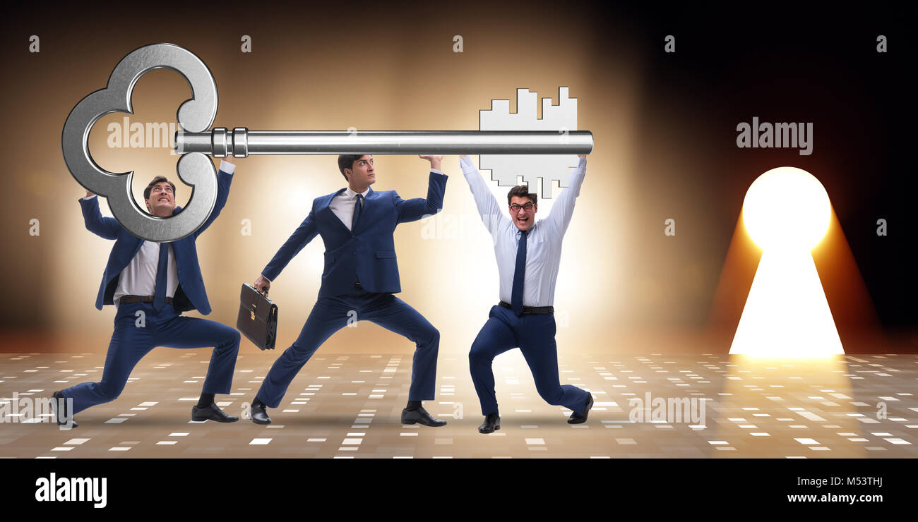 Businessmen holding giant key in business concept Stock Photo - Alamy