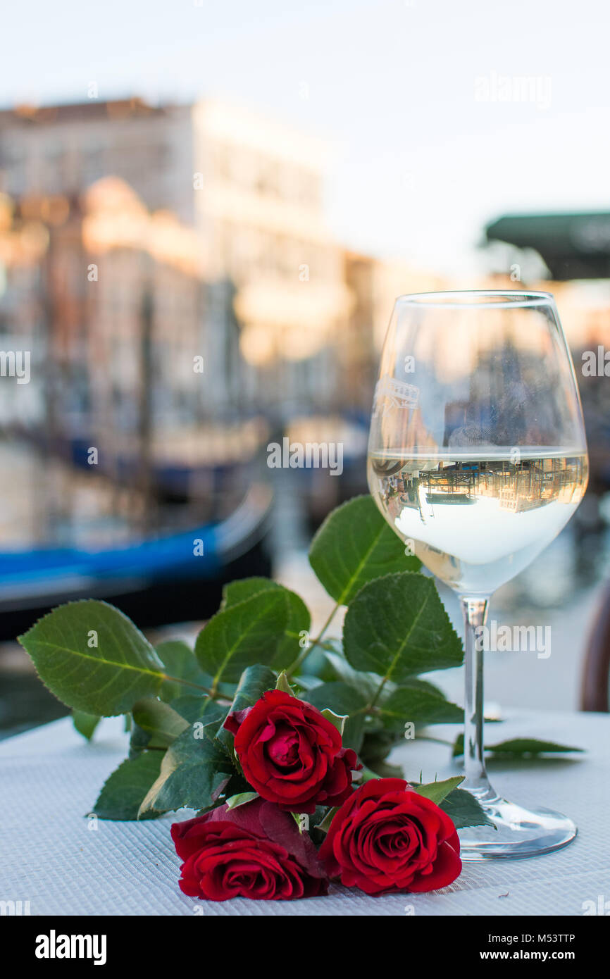 beautiful roses and red wine in front of the amazing Grande canal in ...