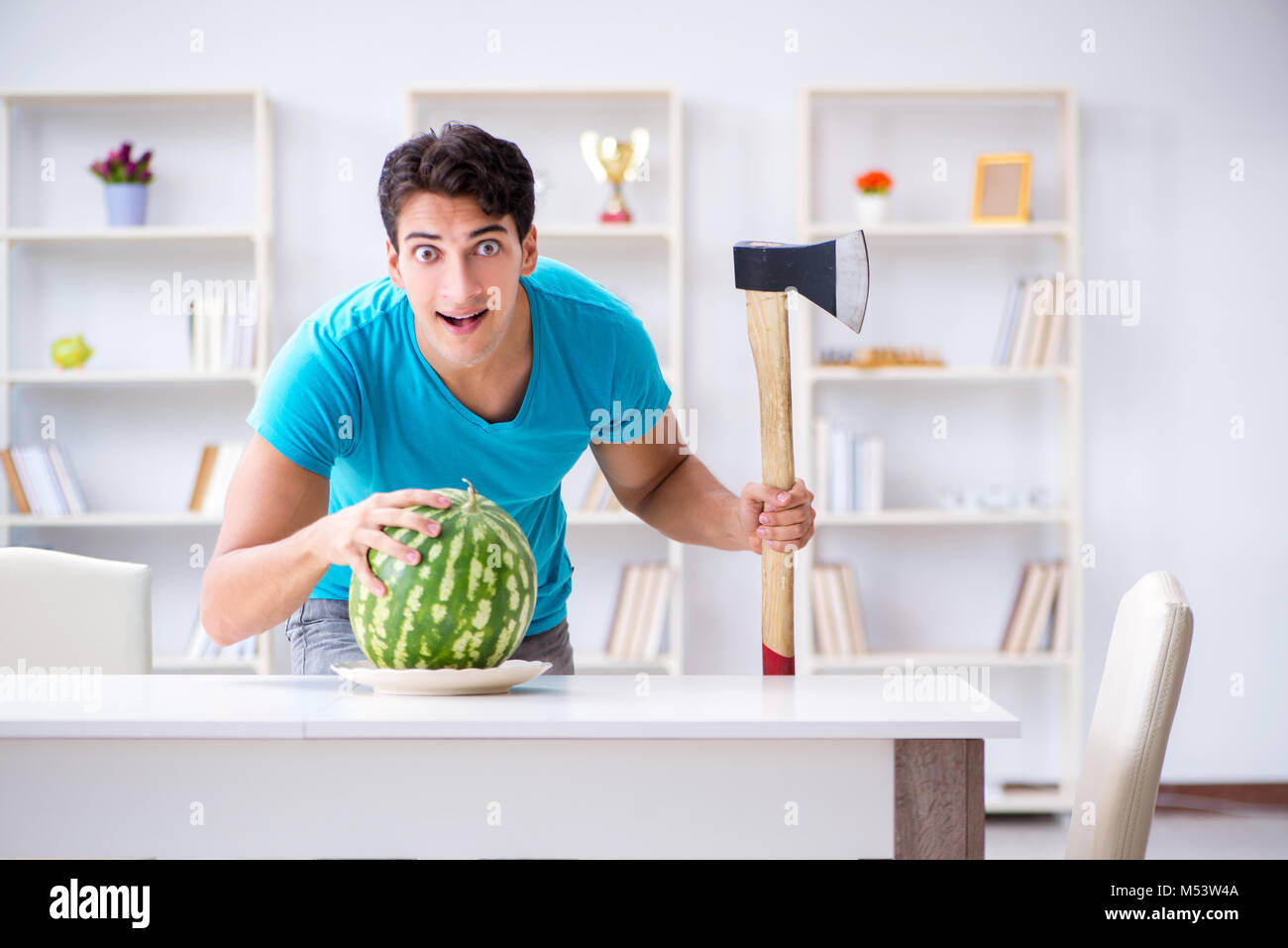 Man eating watermelon at home Stock Photo - Alamy