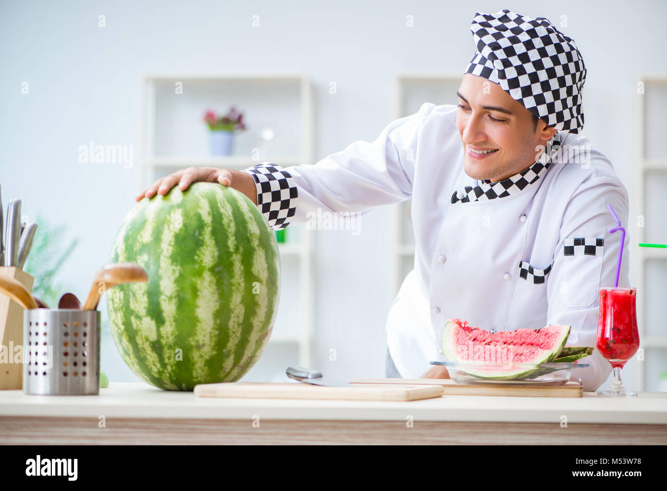 Male cook with watermelon in kitchen Stock Photo - Alamy