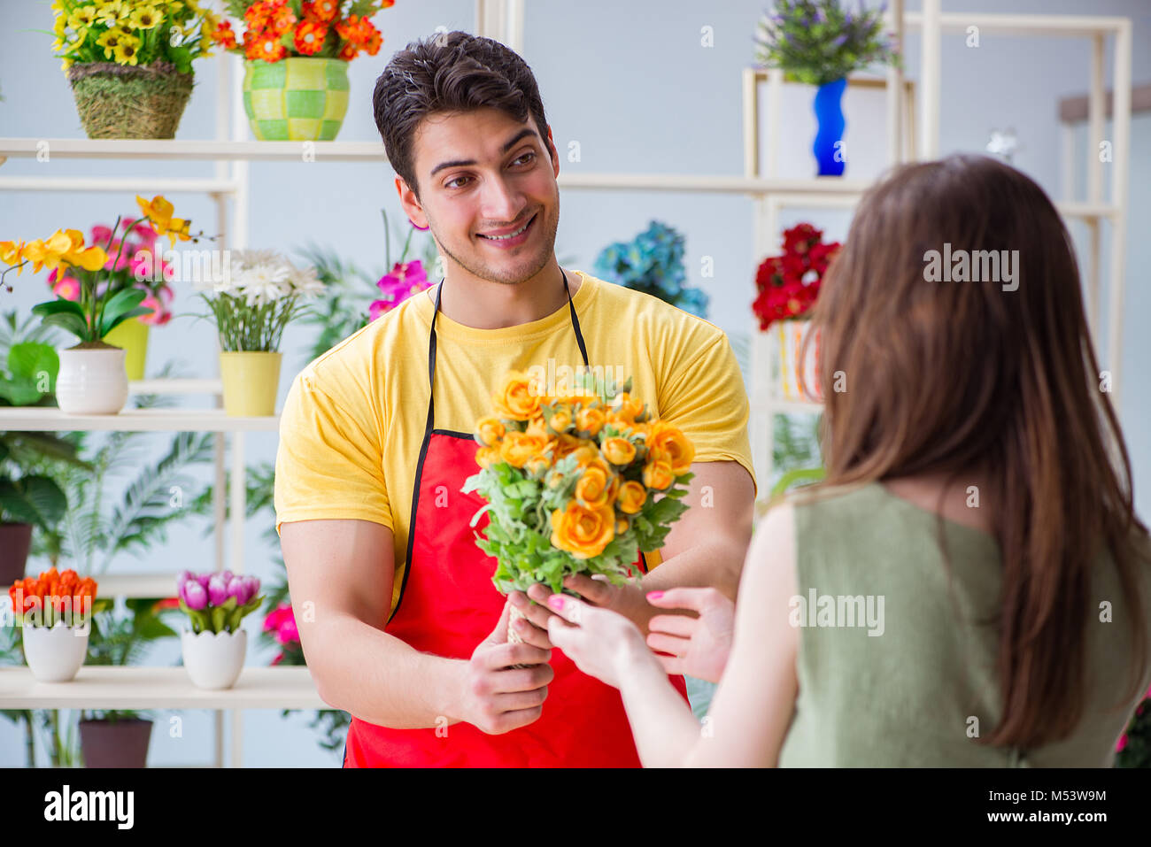 Florist selling flowers in a flower shop Stock Photo - Alamy