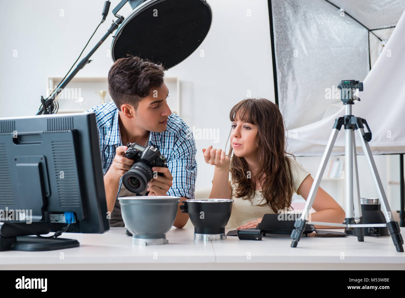 Young photographer working in photo studio Stock Photo - Alamy