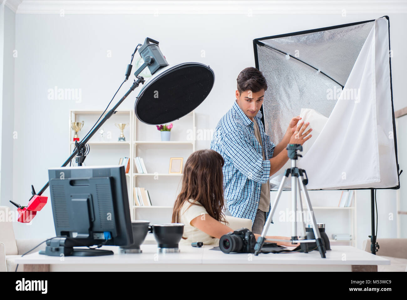 Young photographer working in photo studio Stock Photo - Alamy