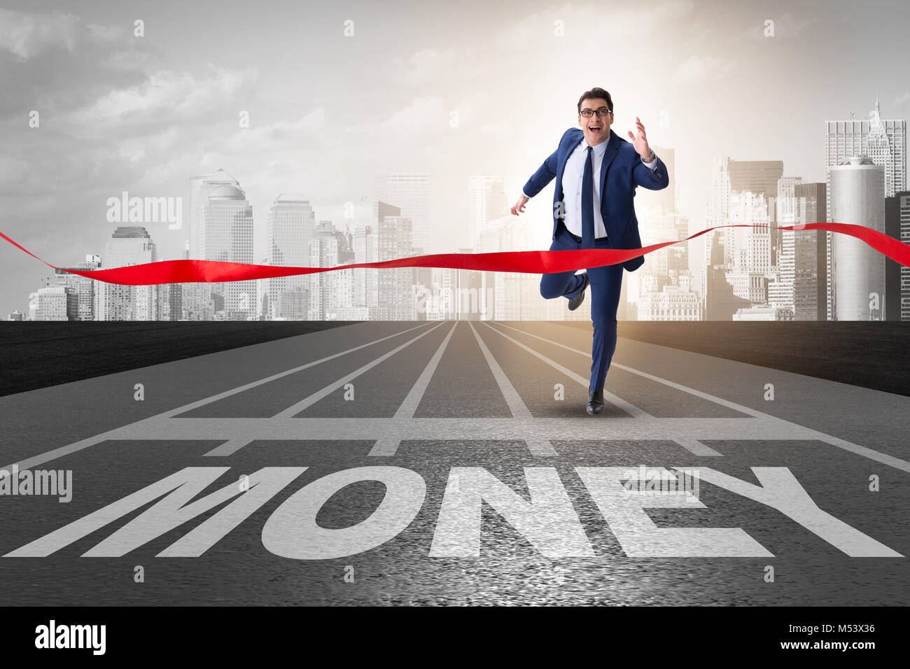 Businessman running towards money on track Stock Photo - Alamy
