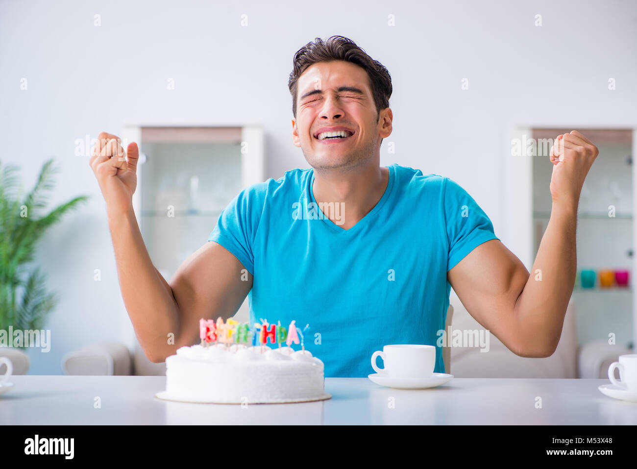 Young man celebrating birthday alone at home Stock Photo - Alamy