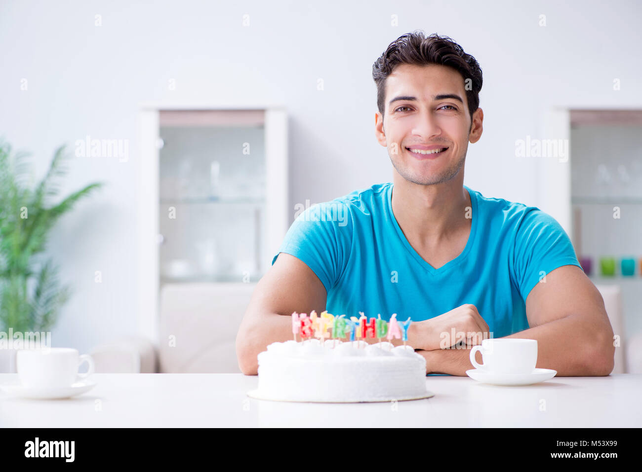 Young man celebrating birthday alone at home Stock Photo - Alamy