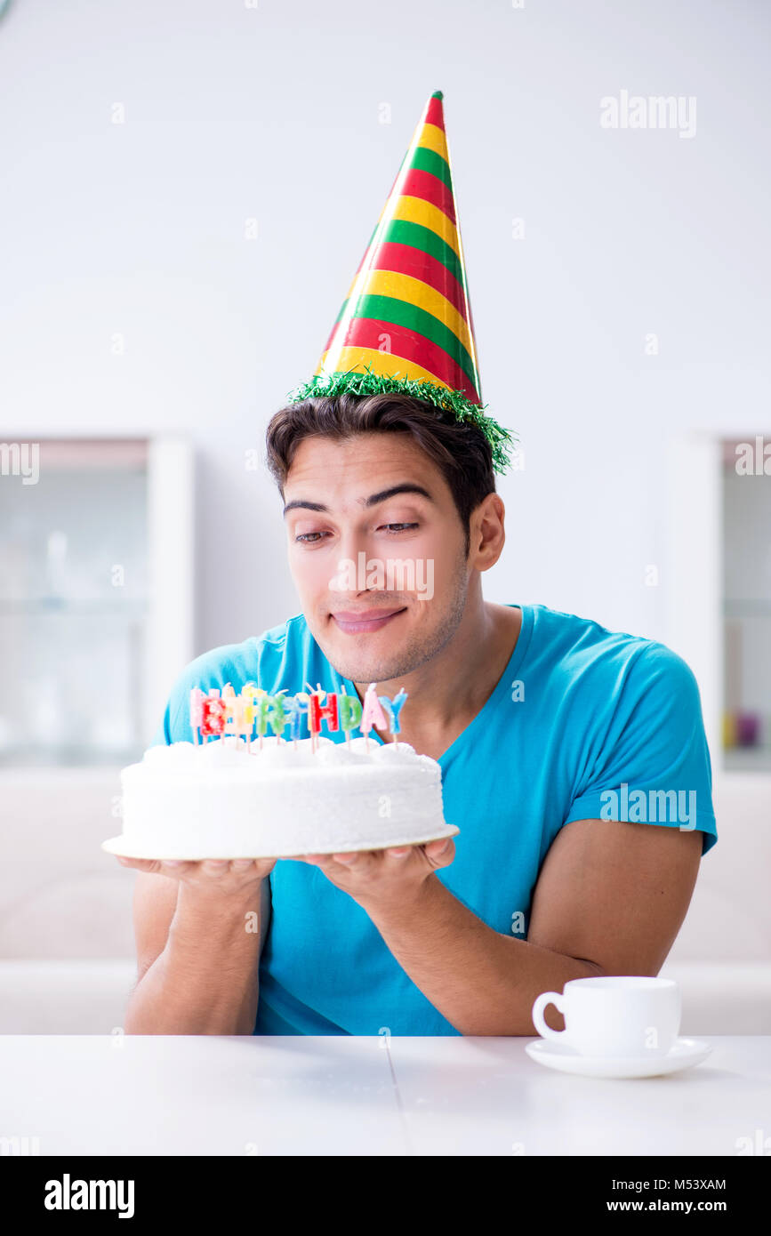 Young man celebrating birthday alone at home Stock Photo - Alamy