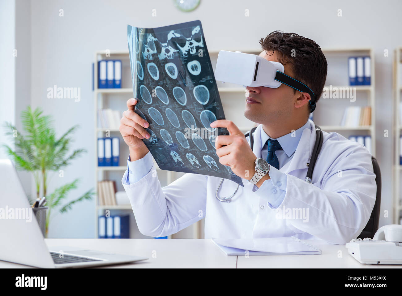 Young doctor looking at MRI scan through VR glasses Stock Photo - Alamy
