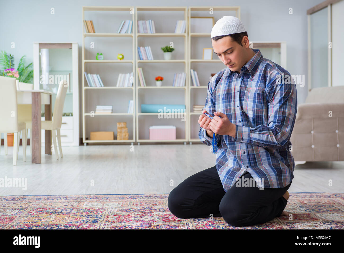 Young muslim man praying at home Stock Photo - Alamy