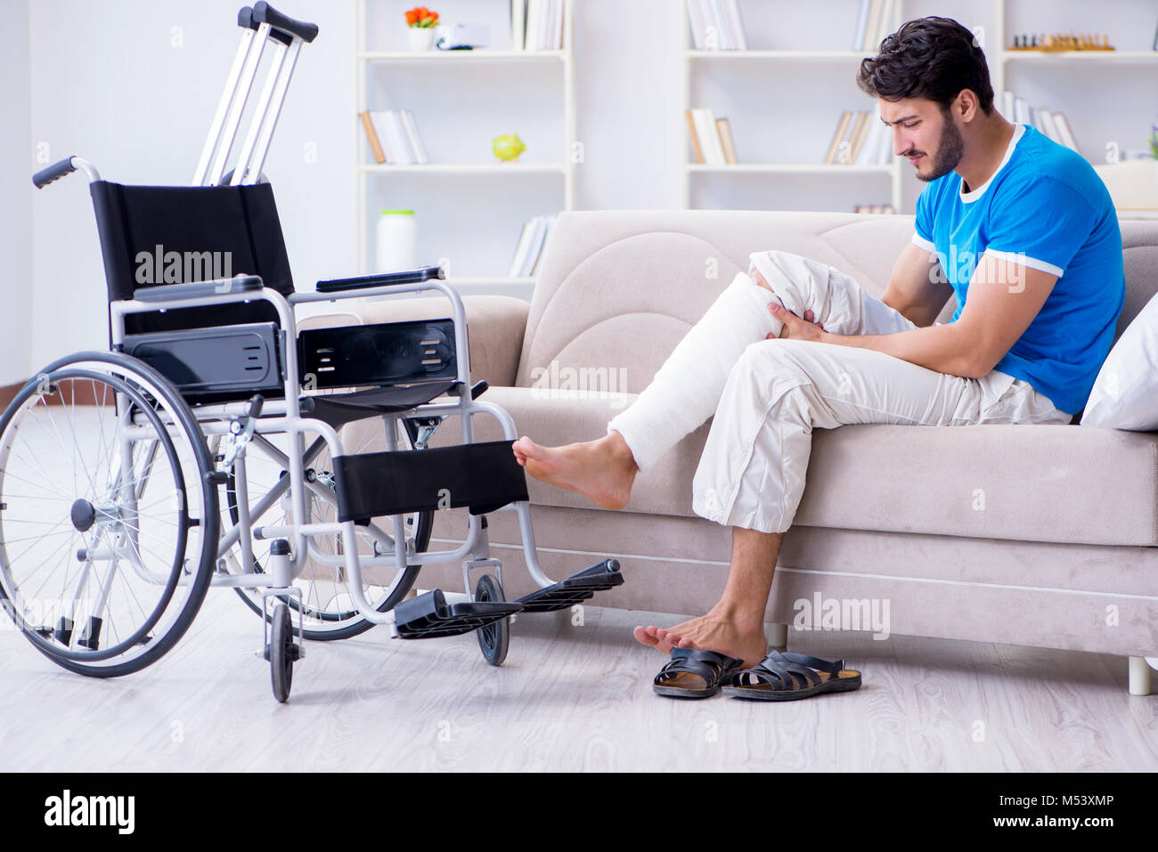 Injured young man recovering at home Stock Photo - Alamy