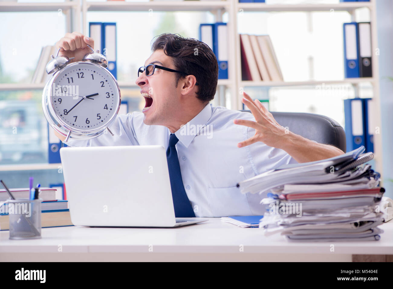 Businessman missing deadline for deliverables in office Stock Photo - Alamy