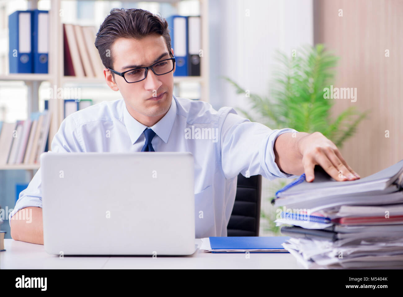 Businessman with excessive work paperwork working in office Stock Photo ...