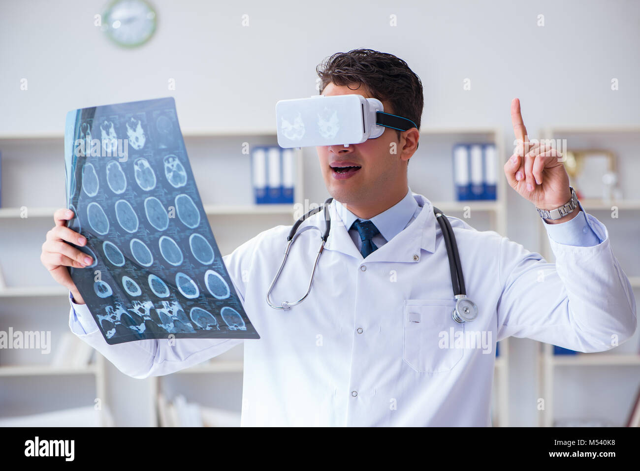 Young doctor looking at MRI scan through VR glasses Stock Photo - Alamy