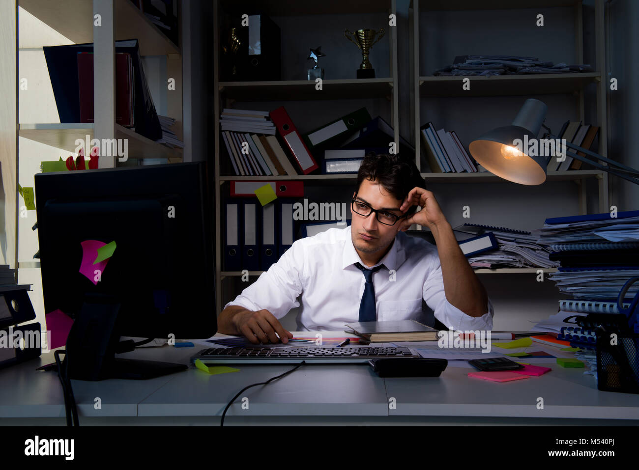 Man businessman working late hours in the office Stock Photo - Alamy