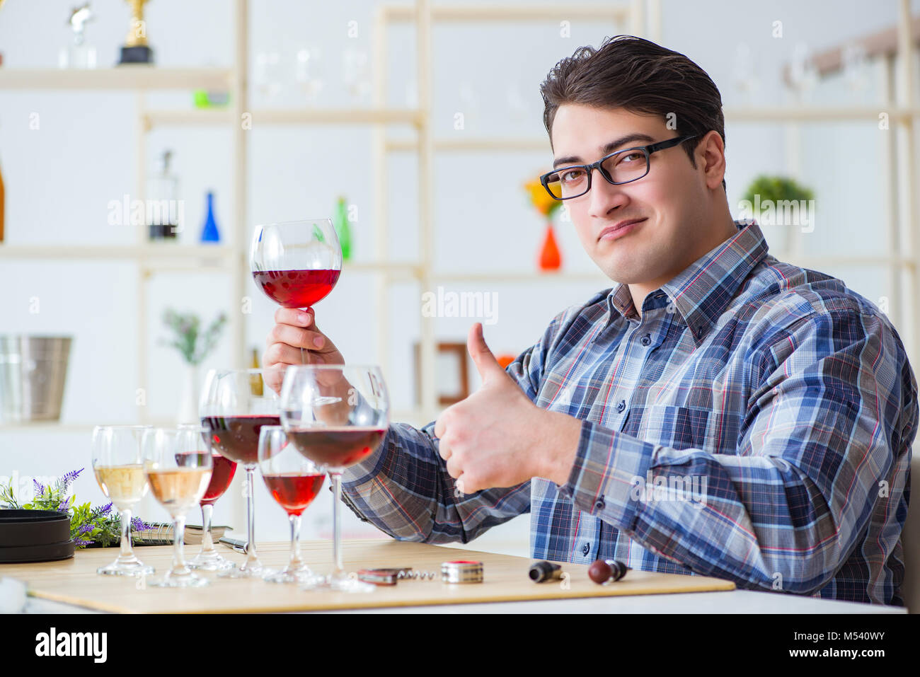 Professional sommelier tasting red wine Stock Photo - Alamy