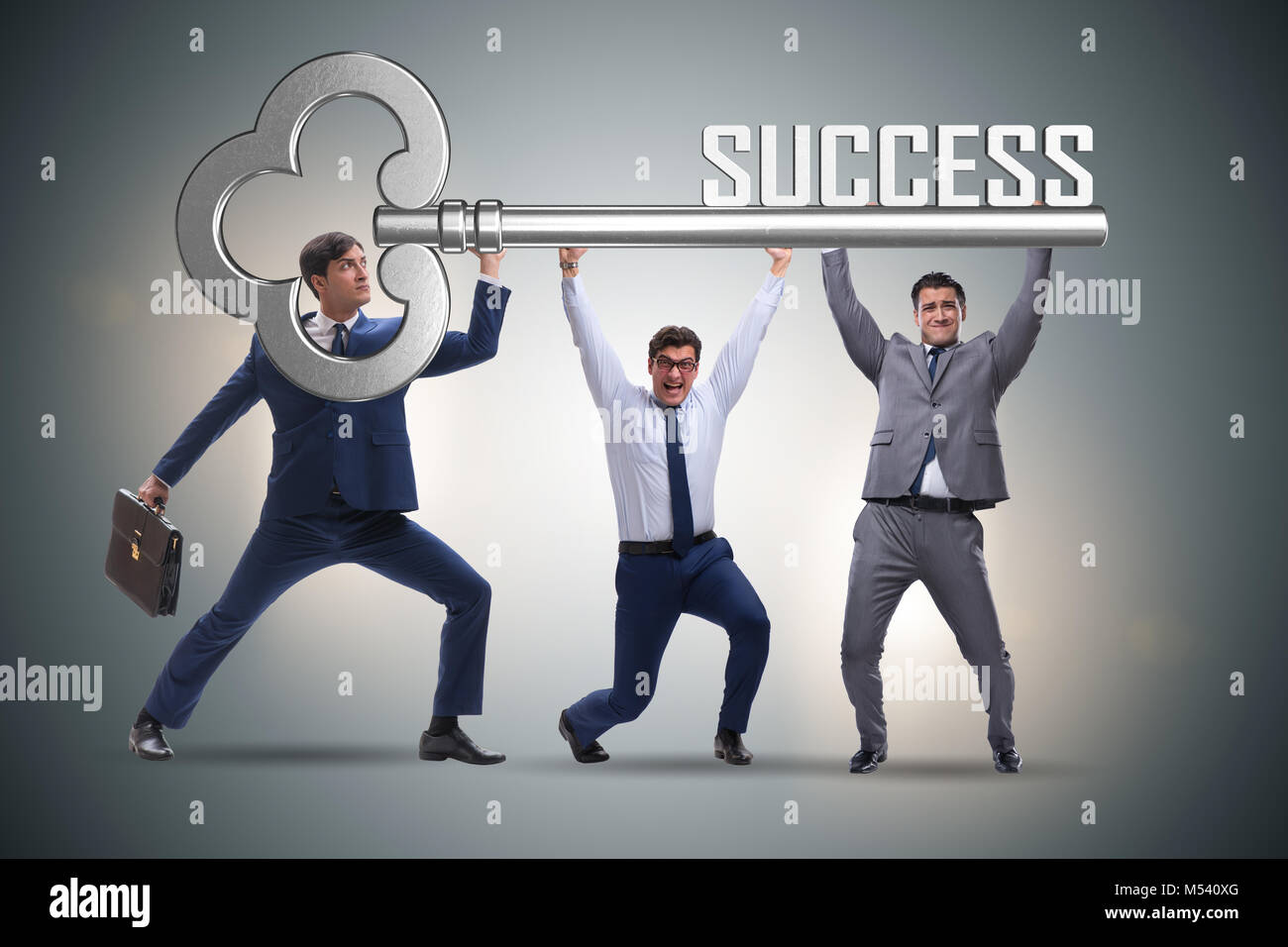 Businessmen holding giant key in business concept Stock Photo - Alamy