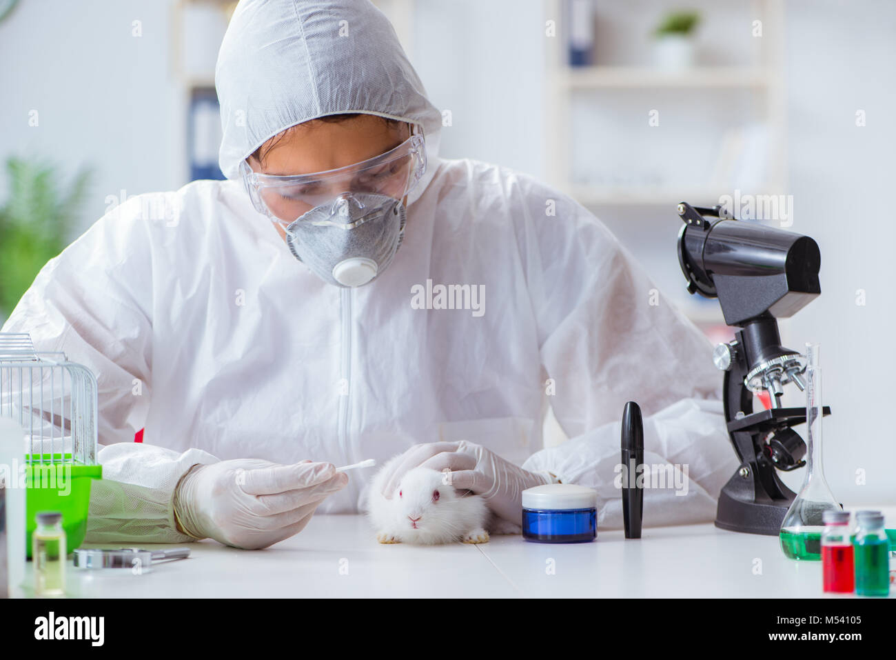 Scientist doing animal experiment in lab with rabbit Stock Photo - Alamy
