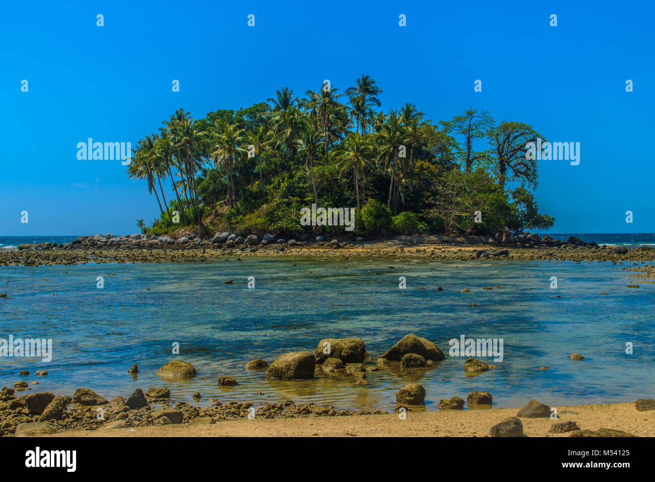 Lonely remote island with rock beach and tree when the sea water ...