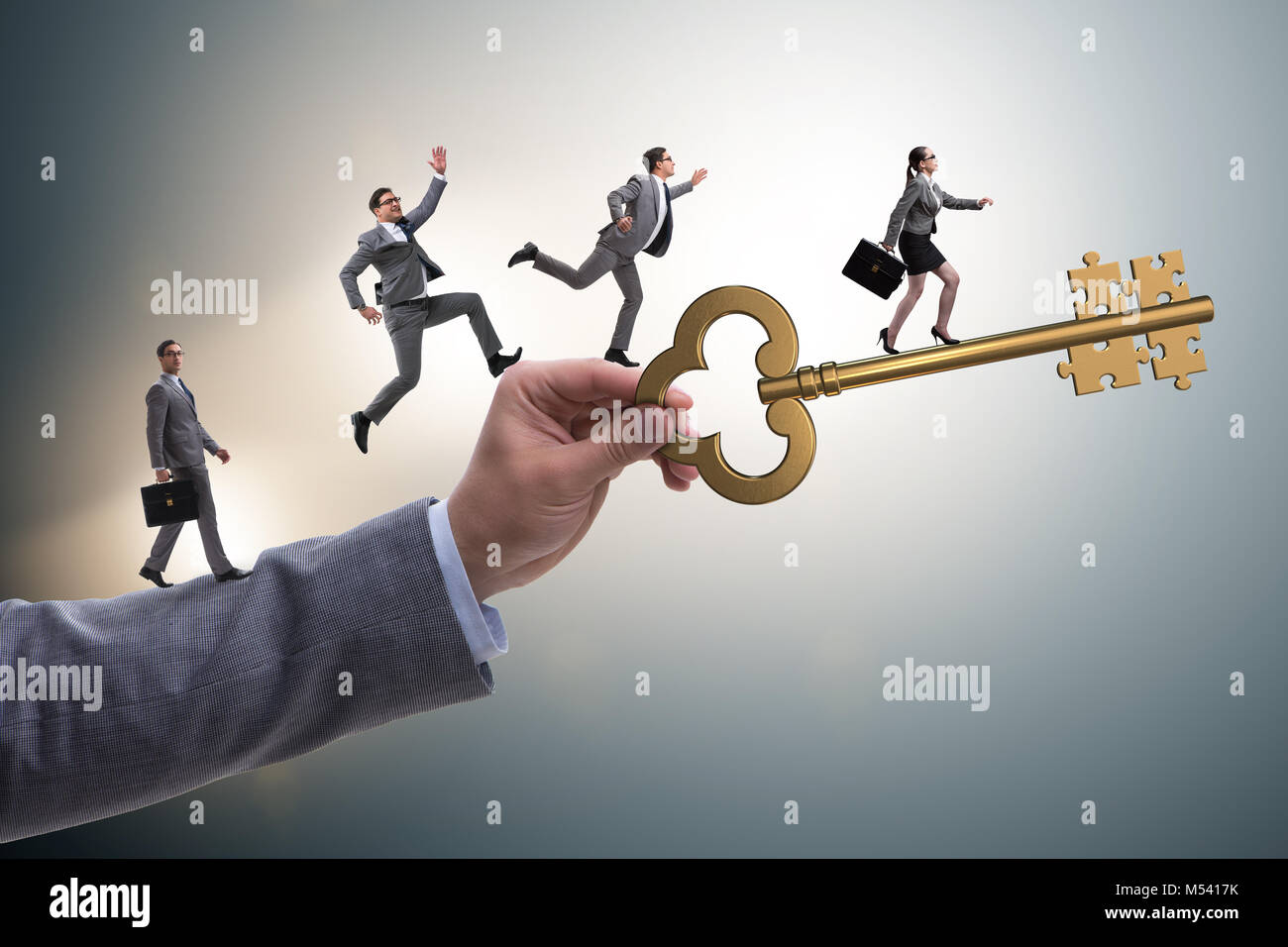 Business people chasing each other towards key to success Stock Photo ...