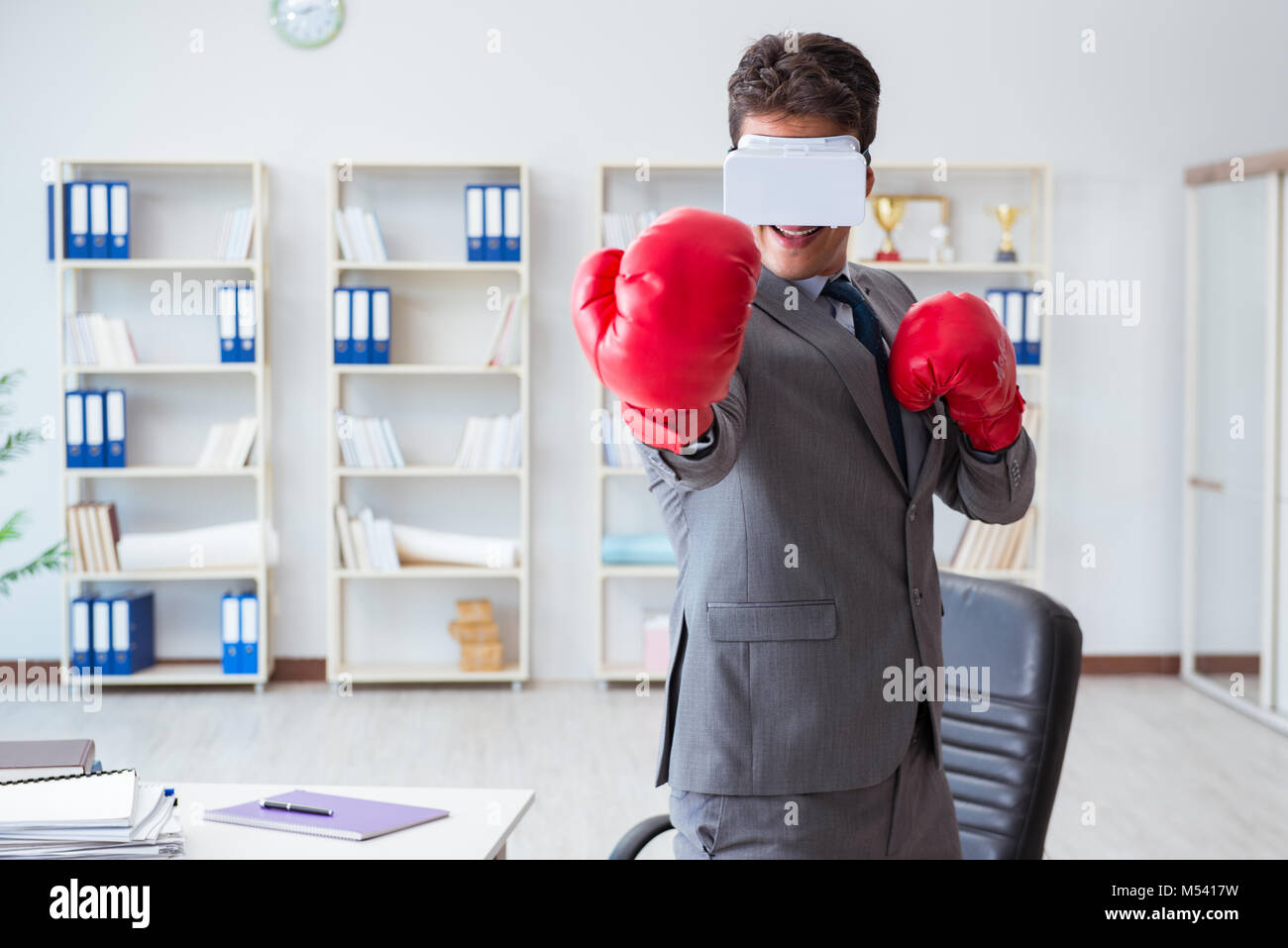 Man boxing in the office with virtual reality goggles Stock Photo - Alamy