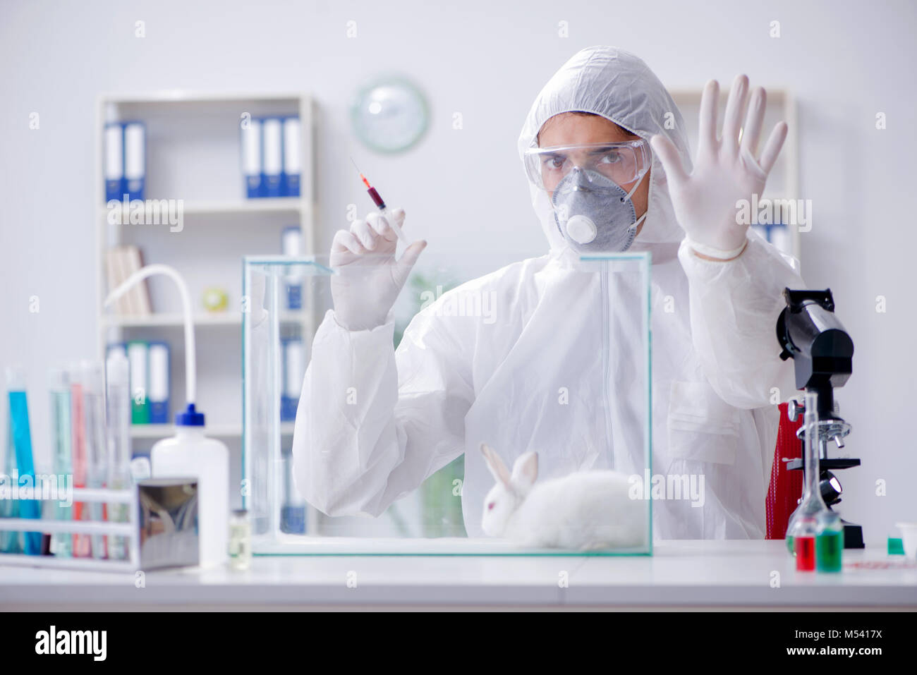 Scientist doing animal experiment in lab with rabbit Stock Photo - Alamy
