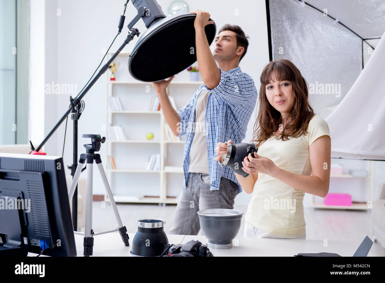 Young photographer working in photo studio Stock Photo - Alamy
