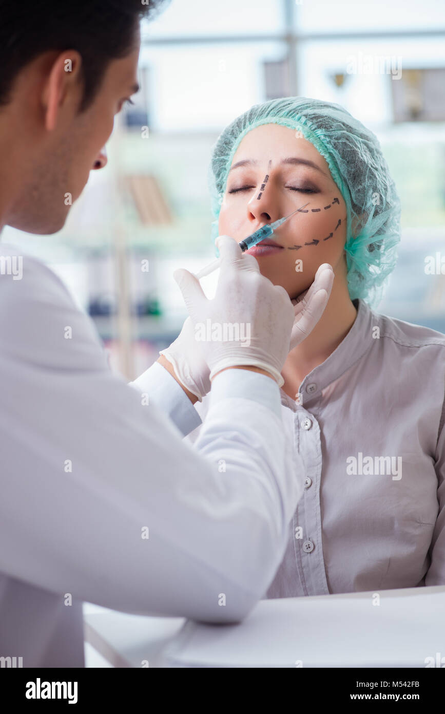 Plastic surgeon preparing for operation on woman face Stock Photo - Alamy