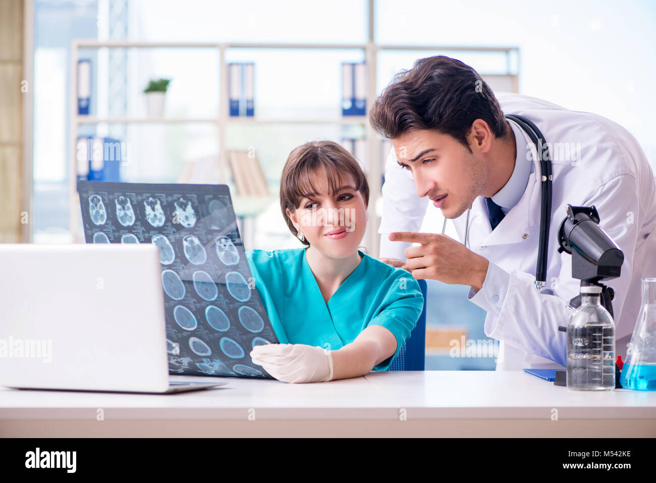 Two doctors discussing x-ray MRI image in hospital Stock Photo - Alamy