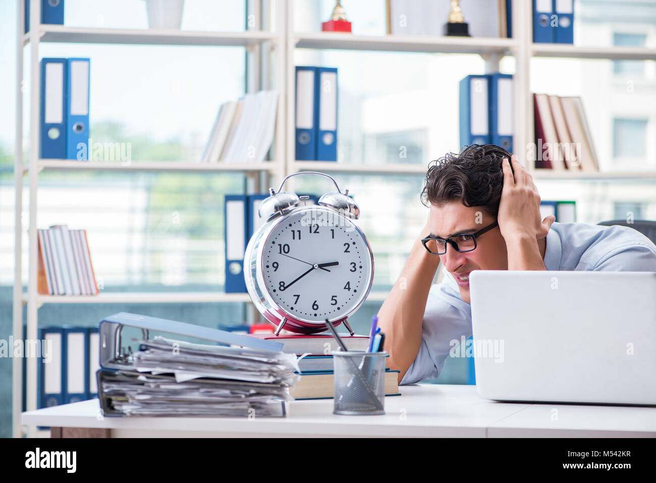 Businessman missing deadline for deliverables in office Stock Photo - Alamy