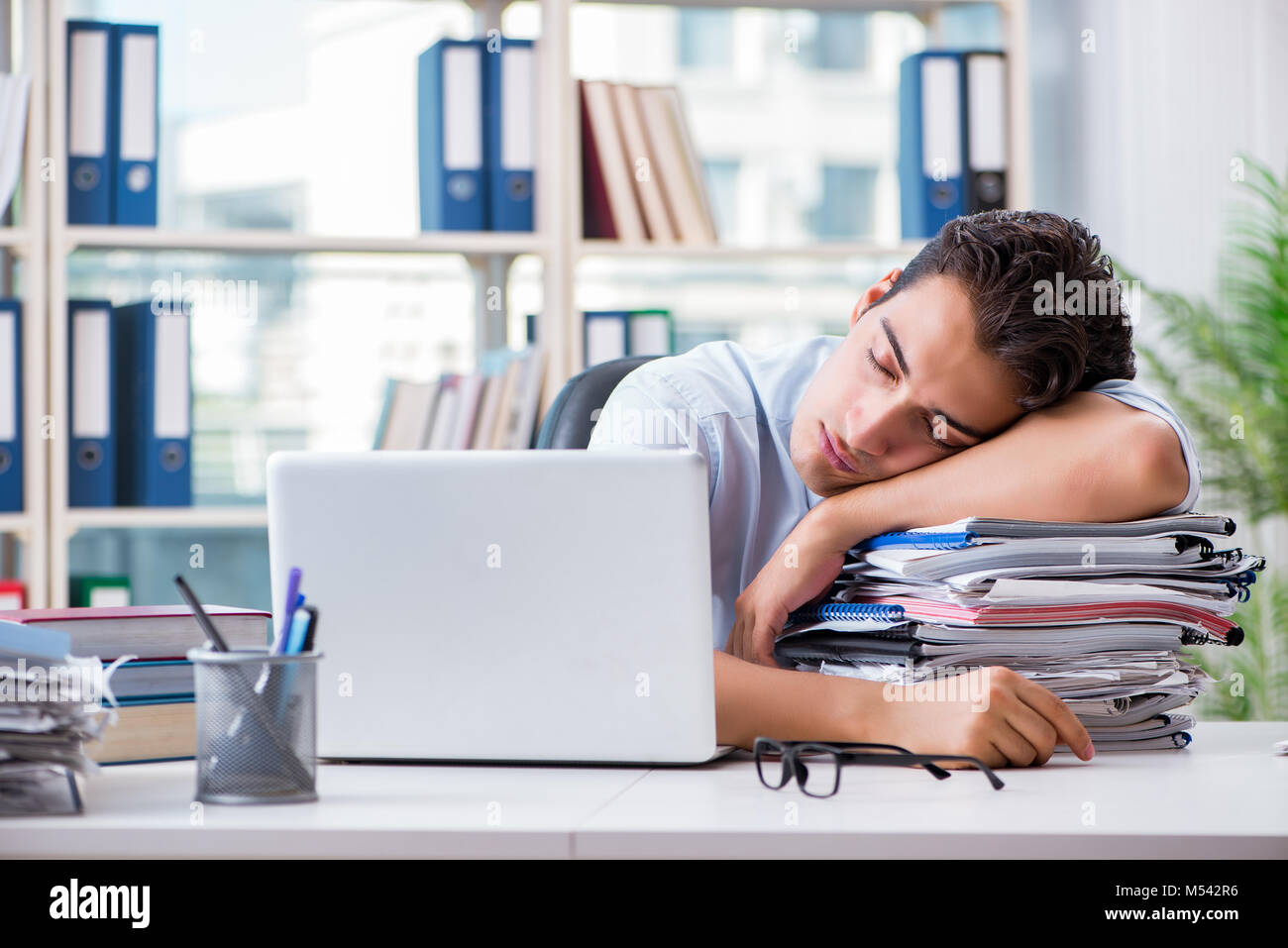 Tired exhausted businessman sitting in the office Stock Photo - Alamy