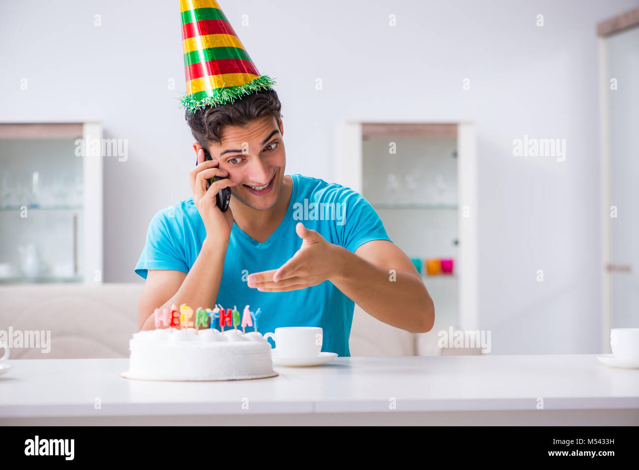 Young man celebrating birthday alone at home Stock Photo - Alamy