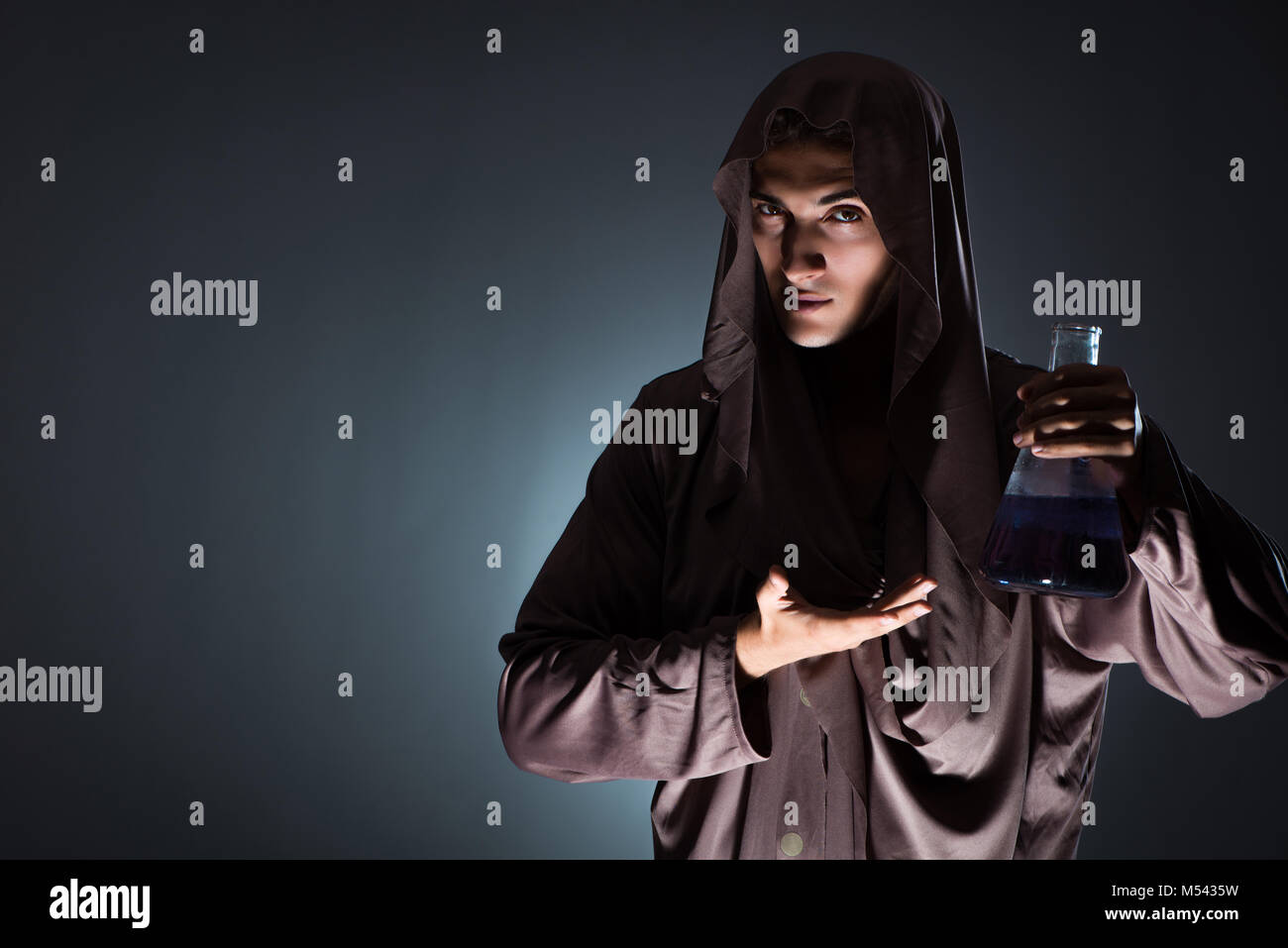 Alchemist doing experiments in alchemy concept Stock Photo - Alamy